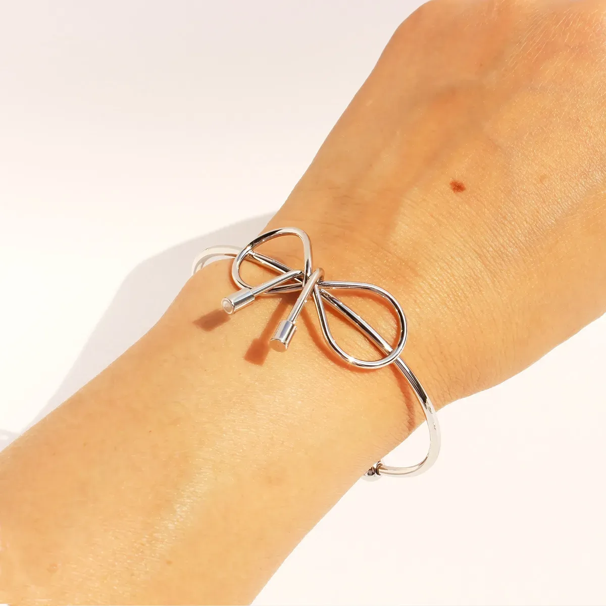 Trendy Silverplated Cuff Bracelet With Bow Detail - NEWME